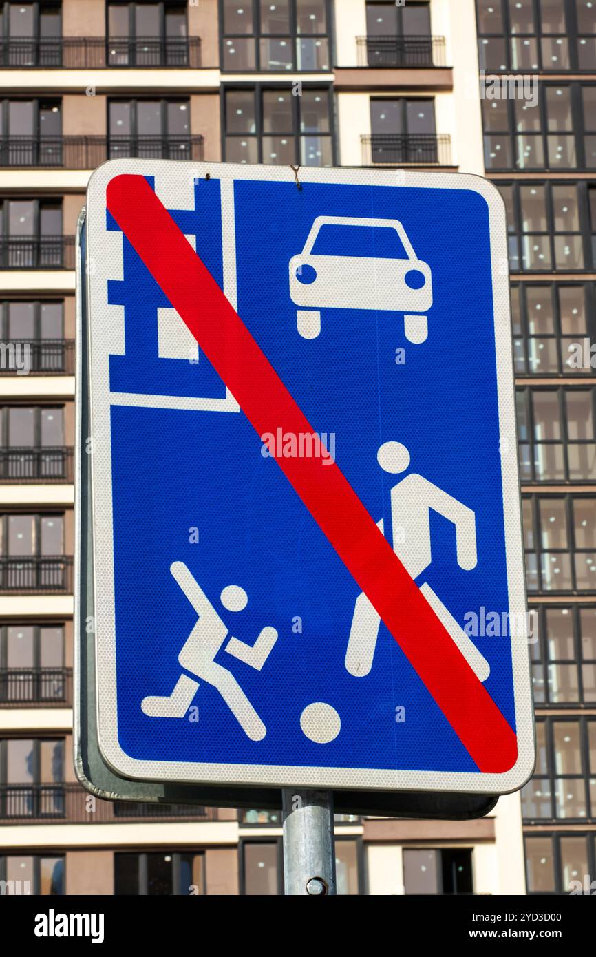 A blue traffic sign featuring a prominent red line striking through its ...