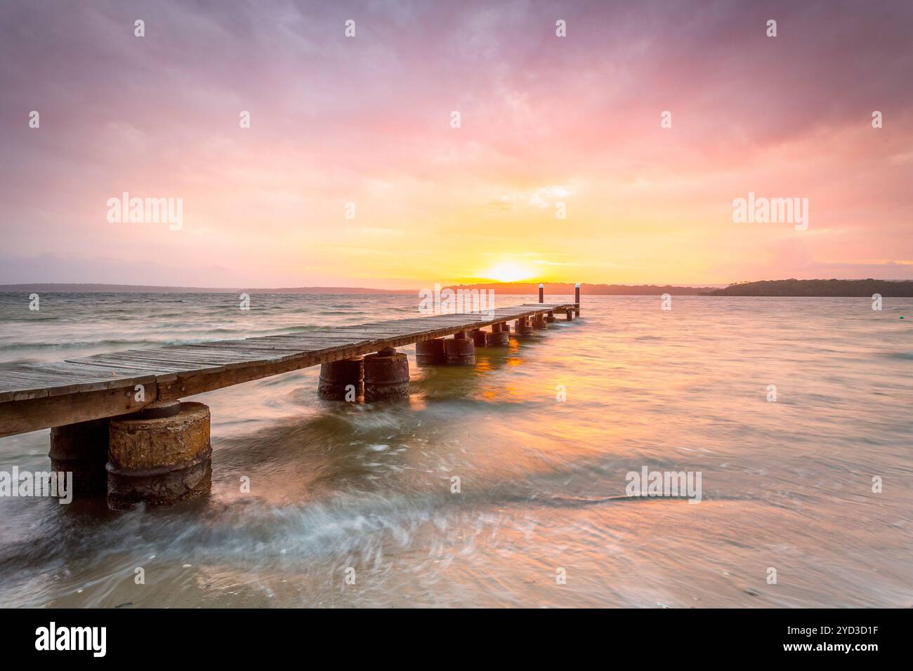 Sunset sky and long timber jetty Stock Photo - Alamy