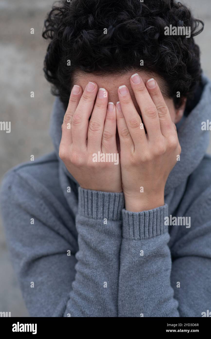 Woman hiding face in hands crying Stock Photo - Alamy