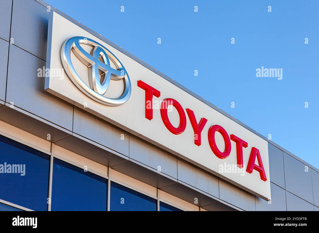 Toyota logo on the building of official dealer Stock Photo - Alamy