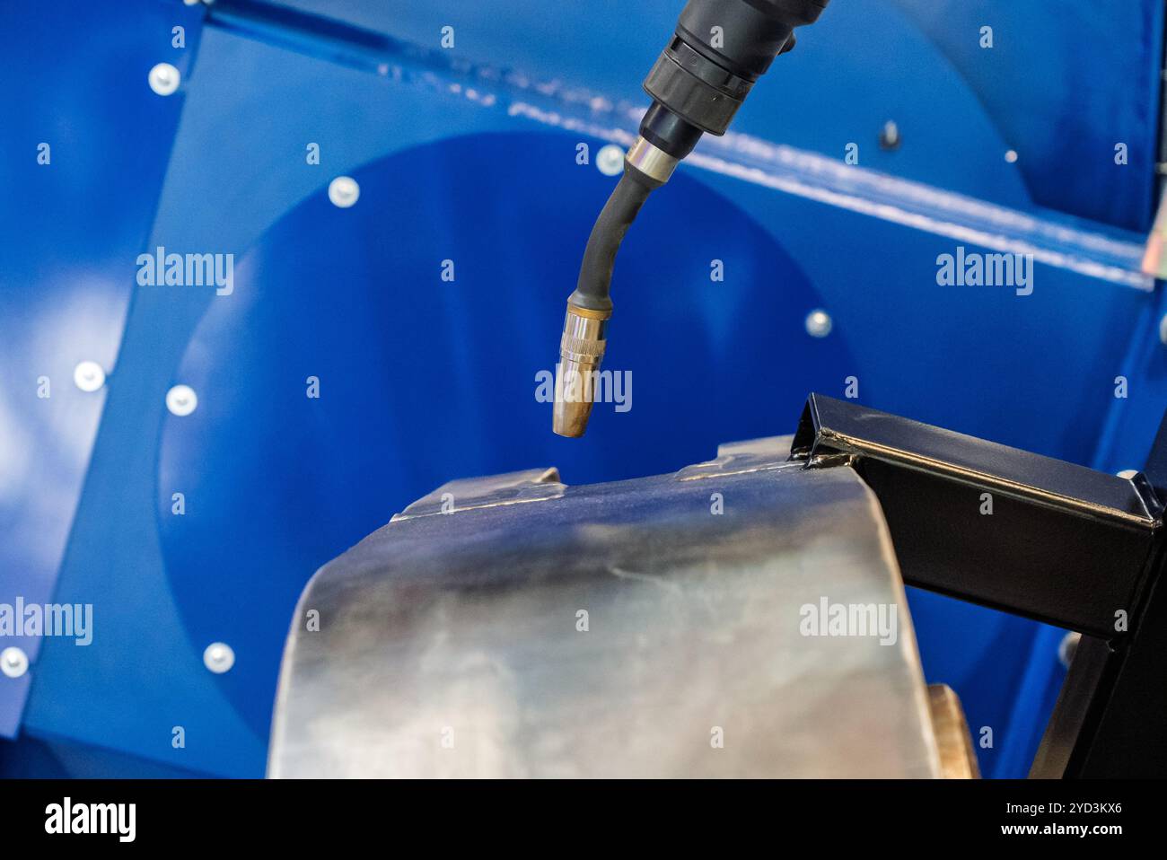 Robot welds steel. Welding head. Welding robot. CNC welding ...