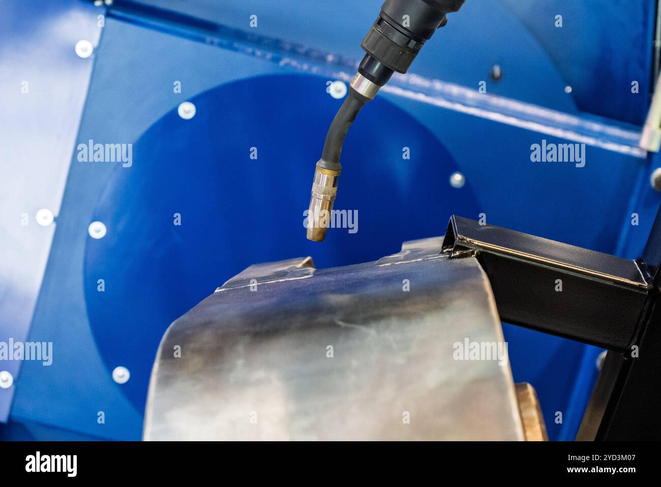 Robot welds steel. Welding head. Welding robot. CNC welding ...