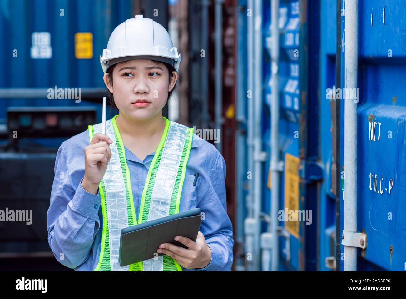Port cargo Asian young women worker consider stress thinking expression ...