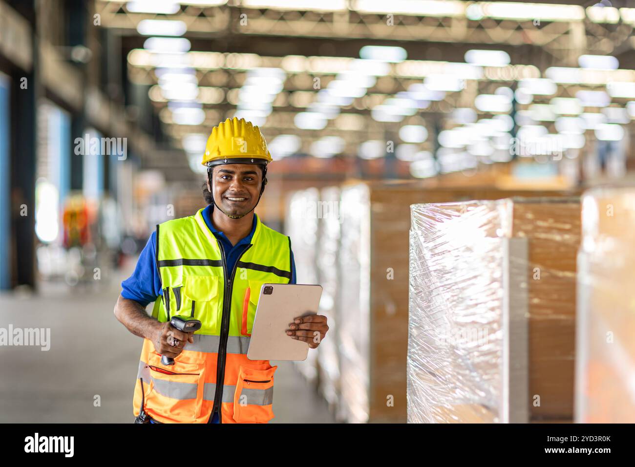 Portrait Happy Indian male worker inventory barcode check. Warehouse ...