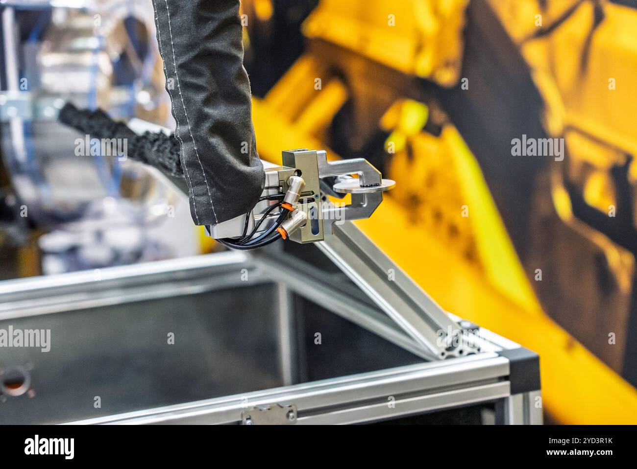 Industrial robotics. Robot opens container. Robot arm opens and closes ...