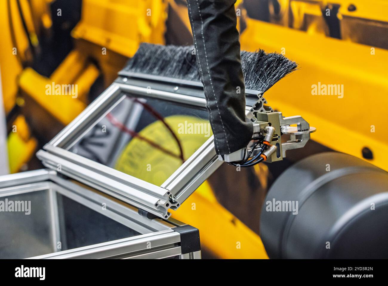 Industrial robotics. Robot opens container. Robot arm opens and closes ...
