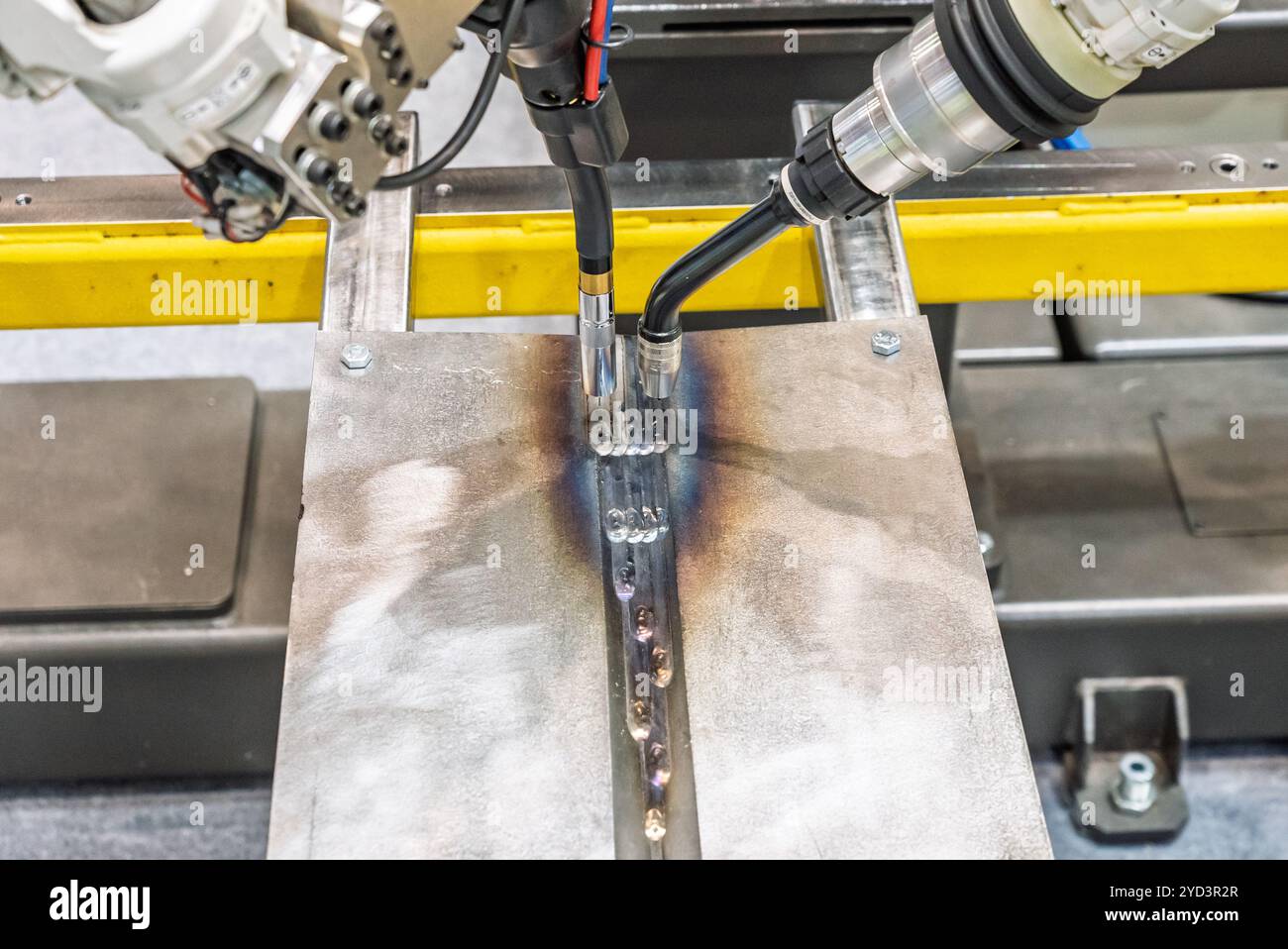 Robot welds steel. Welding head. Welding robot. CNC welding ...