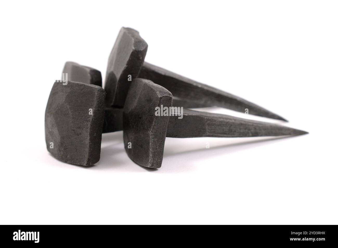 Forged nails on a neutral background Stock Photo - Alamy