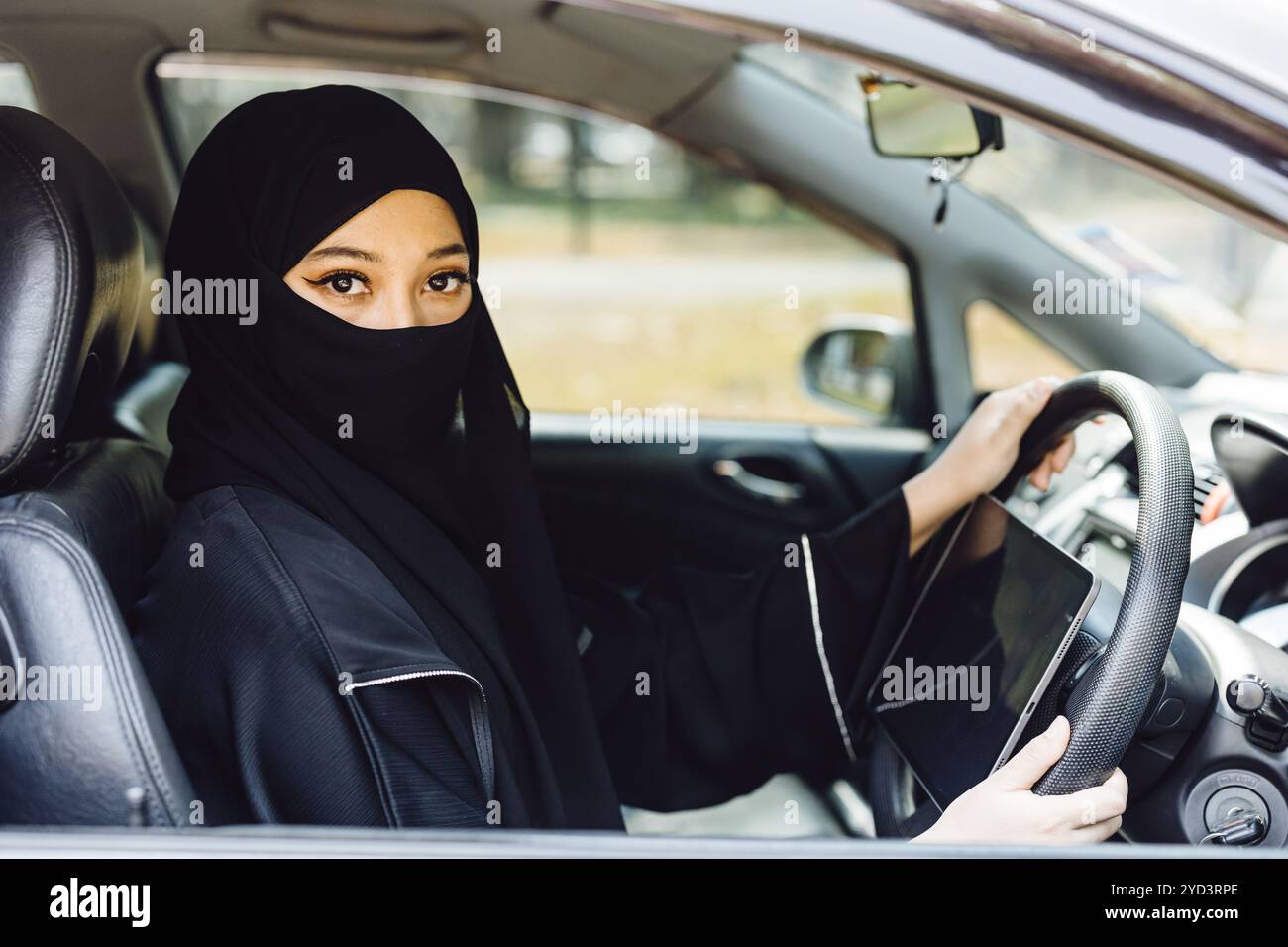 Middle Eastern Woman Driving a Car face covered black niqab dressing ...