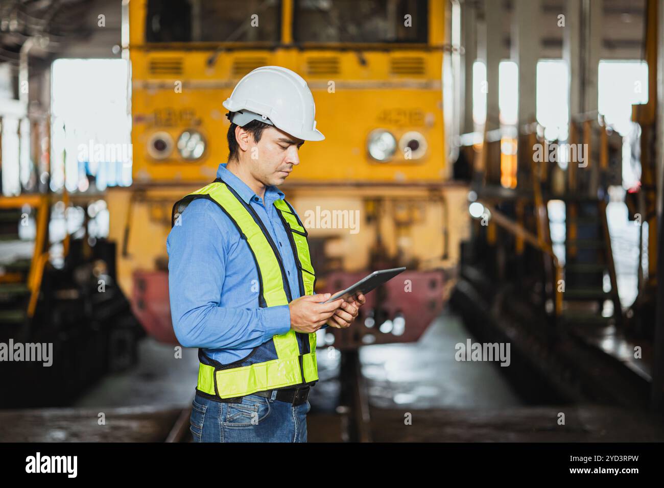 Locomotive engineer male supervisor working train service using tablet ...