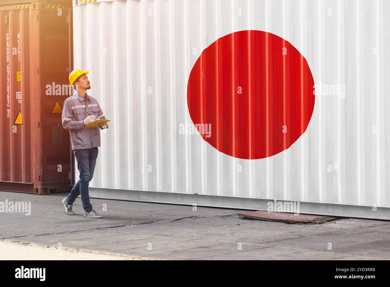 Flag of Japan paint on container with Japanese male worker work in port ...