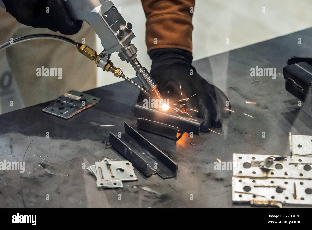 Robot welds steel. Welding head. Welding robot. CNC welding. Robotization and automation of the ...