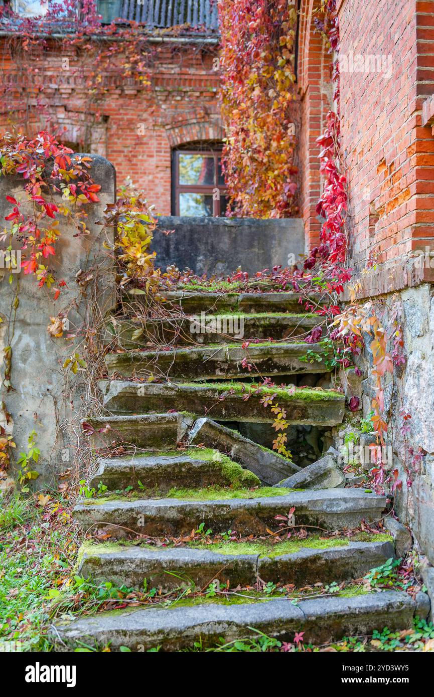 Old broken outdoor staircase against the red brick house. The steps are ...