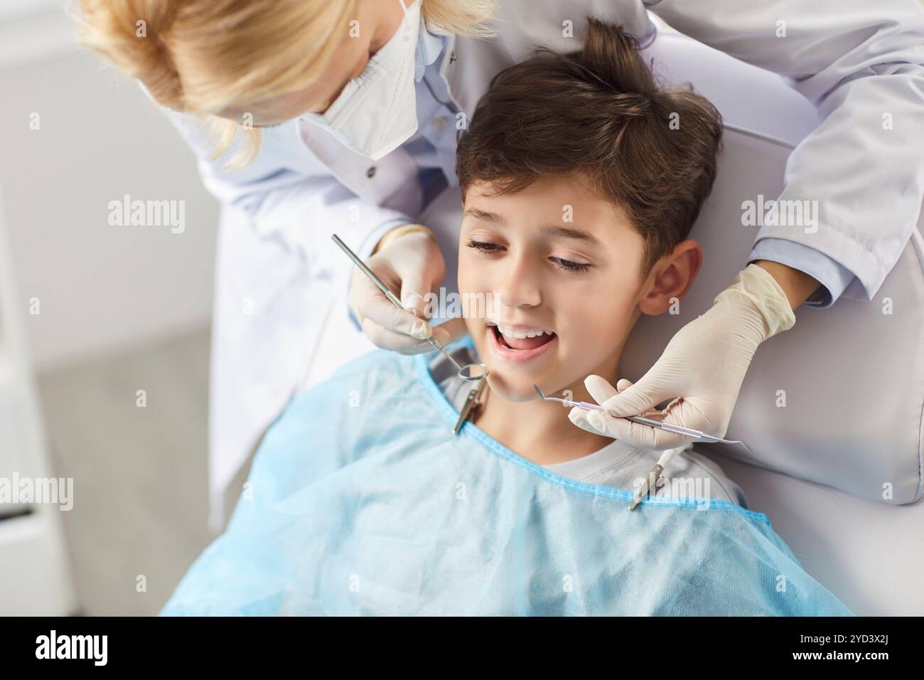 In a dental clinic, a doctor examines a boys teeth, close-up Stock ...