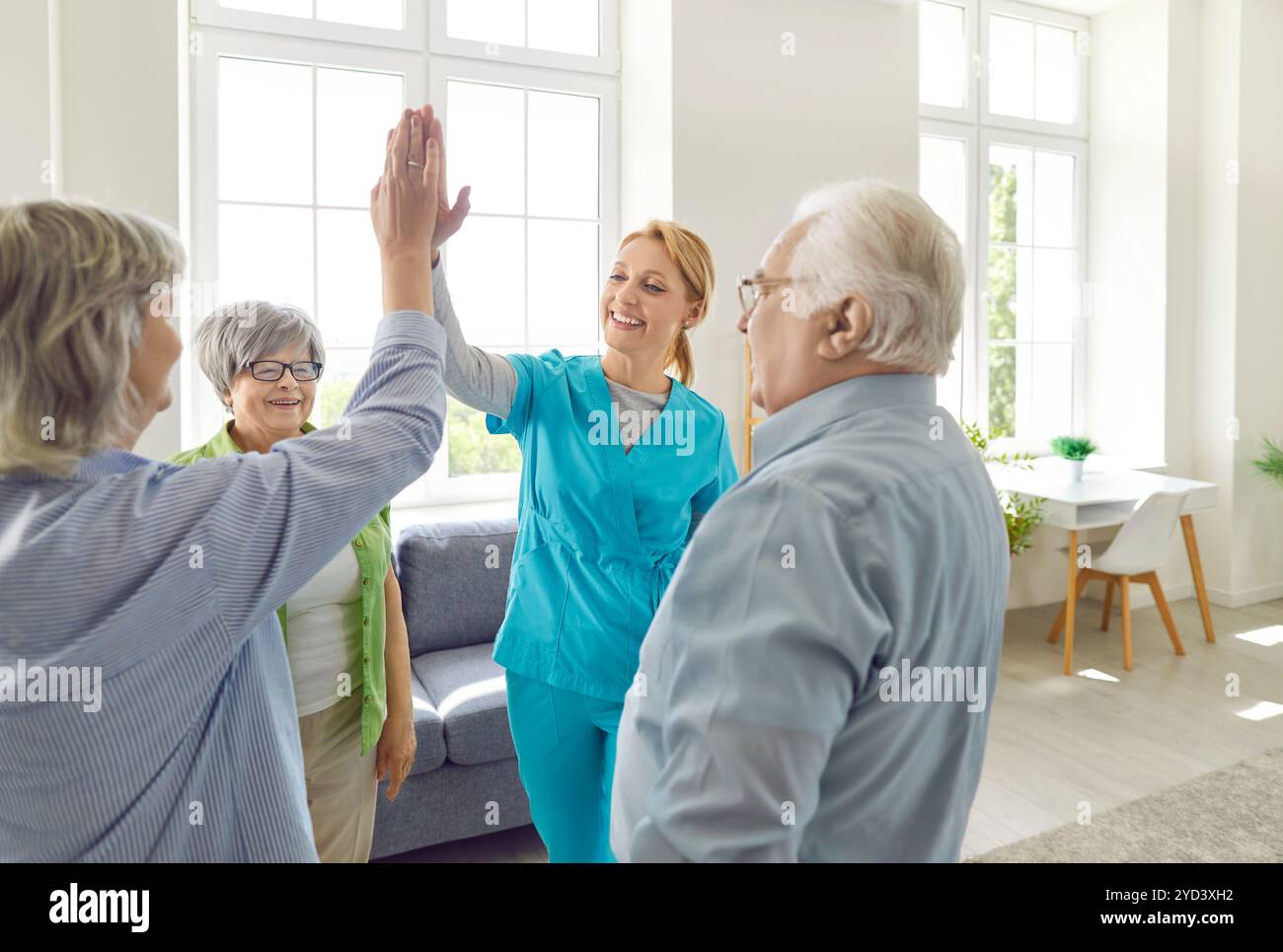Senior people retirement home activity, high five with skilled nurse ...