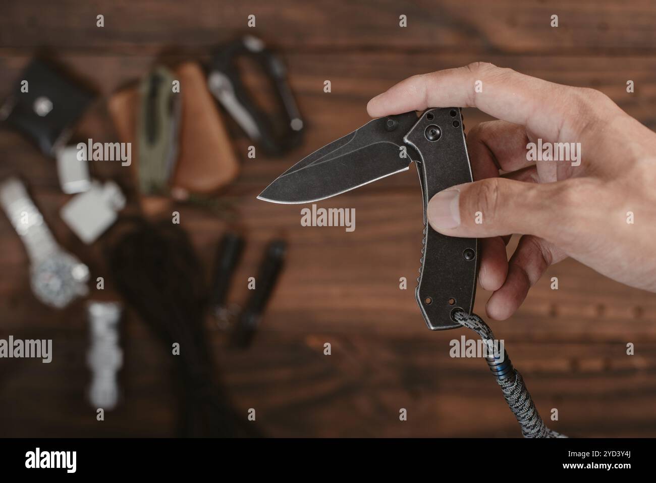 The man using folding knife. Close up folding knife in hand. EDC for ...