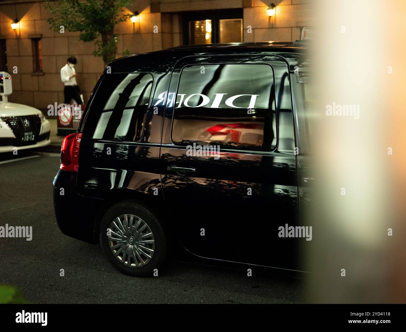 Illuminated Dior sign reflecting in a taxi window in Ginza district ...
