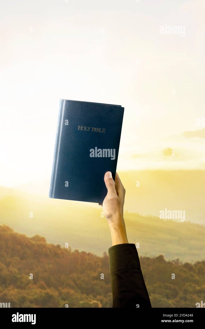 Man holding a holy bible in his hand. Symbol of faith and worship in ...