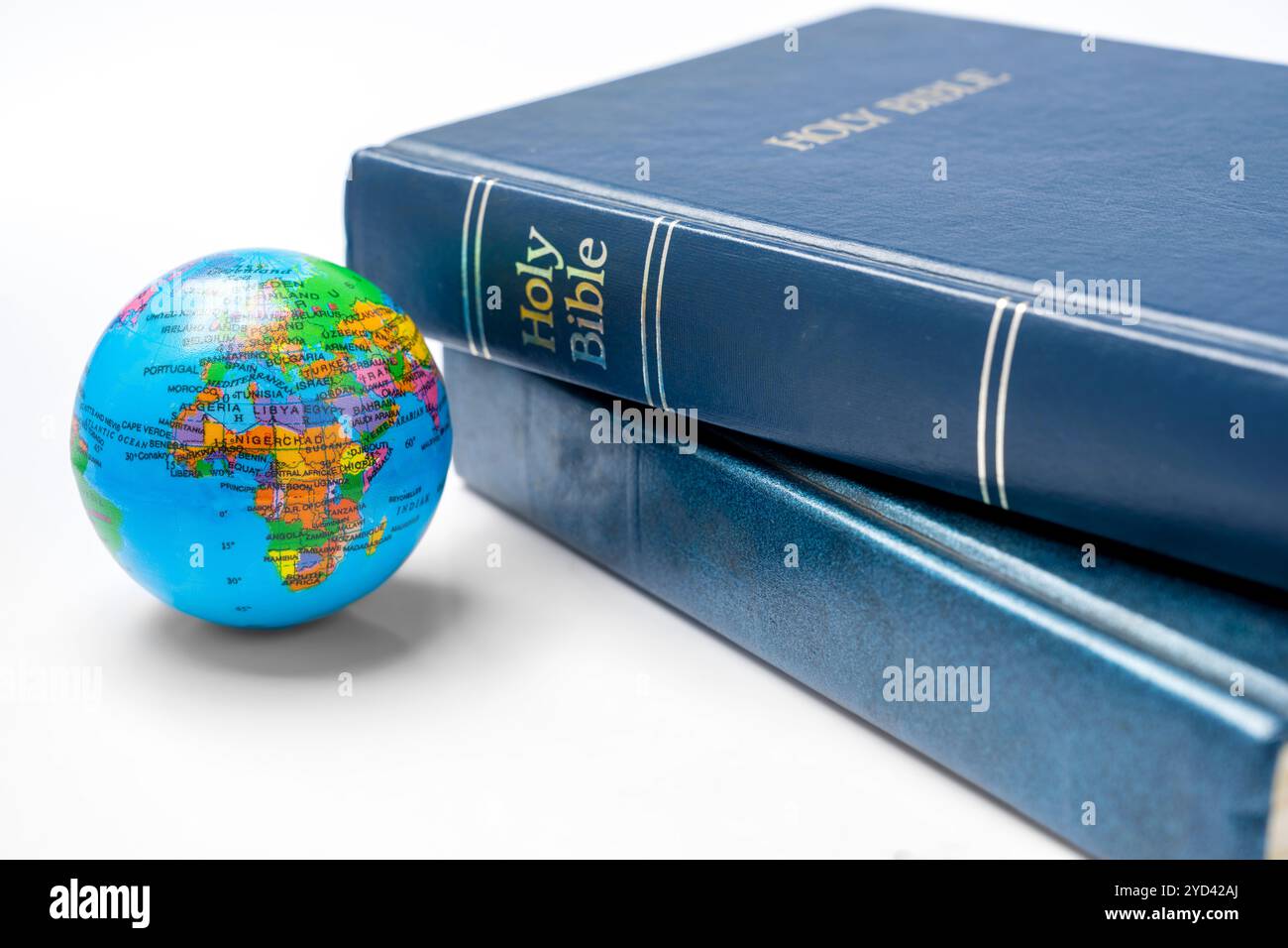 Book of Holy Bible with globe. It is laying on white background. Symbol ...