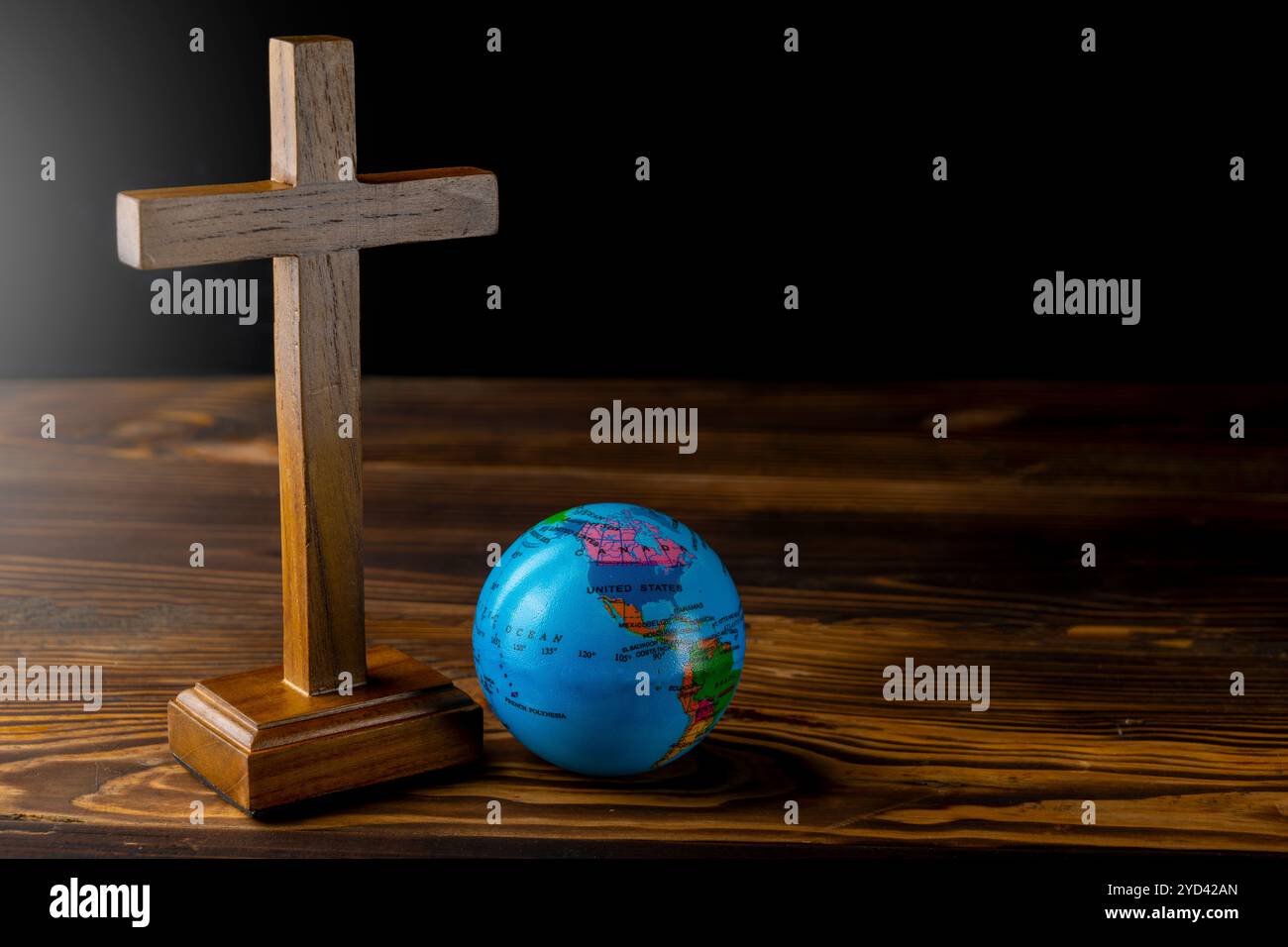 Religion christianity cross and globe on the table. Symbol of faith and ...