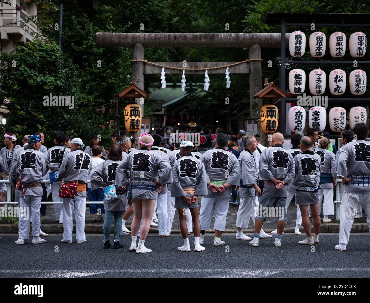 People gathering on the street for a mikoshi parade in Shinjuku, Tokyo ...