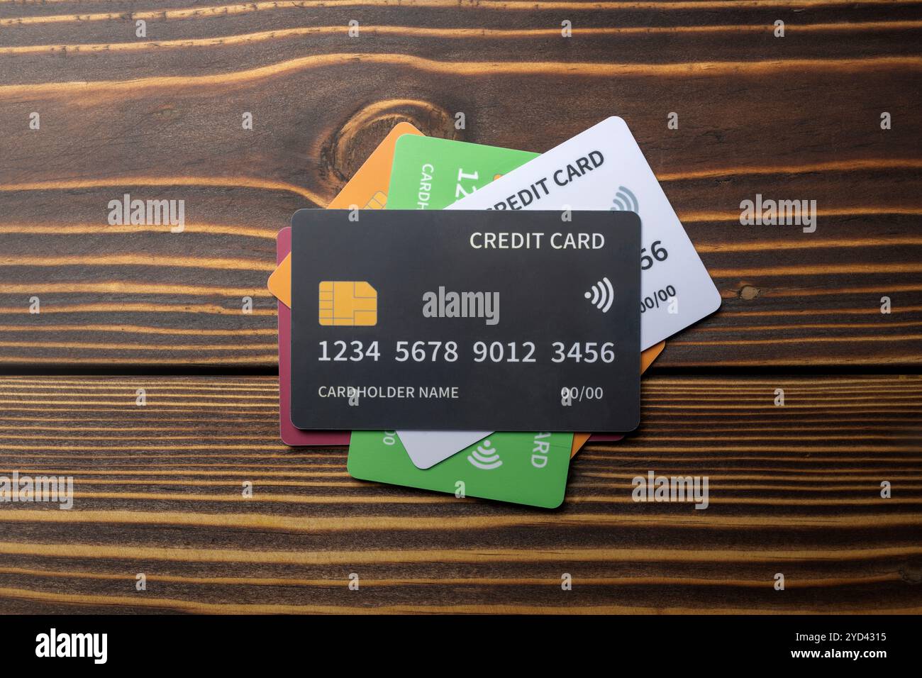 Top view of stack of debit or credit card on wooden background. The ...