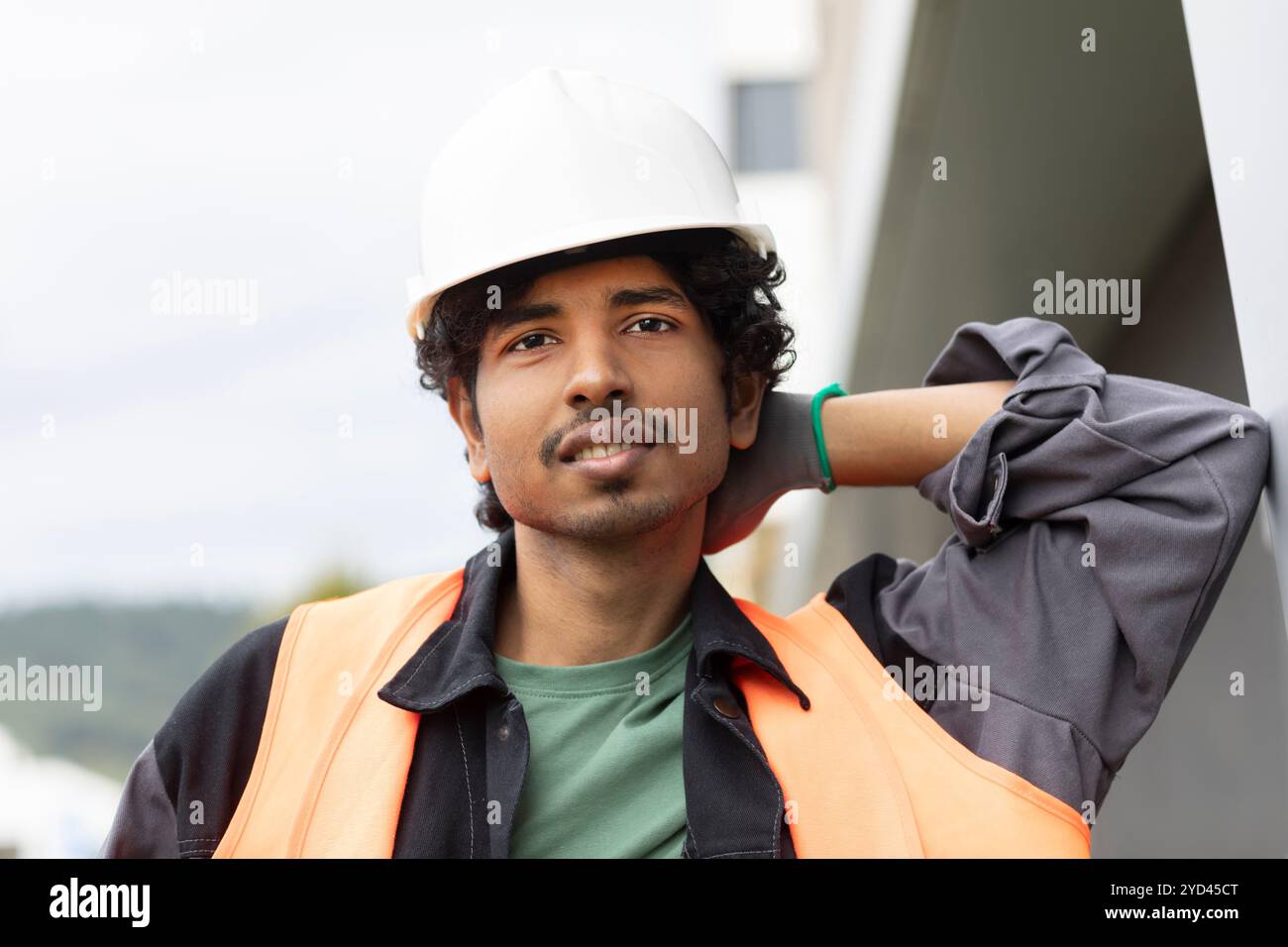portrait, young technician male with helmet and safety vest working ...