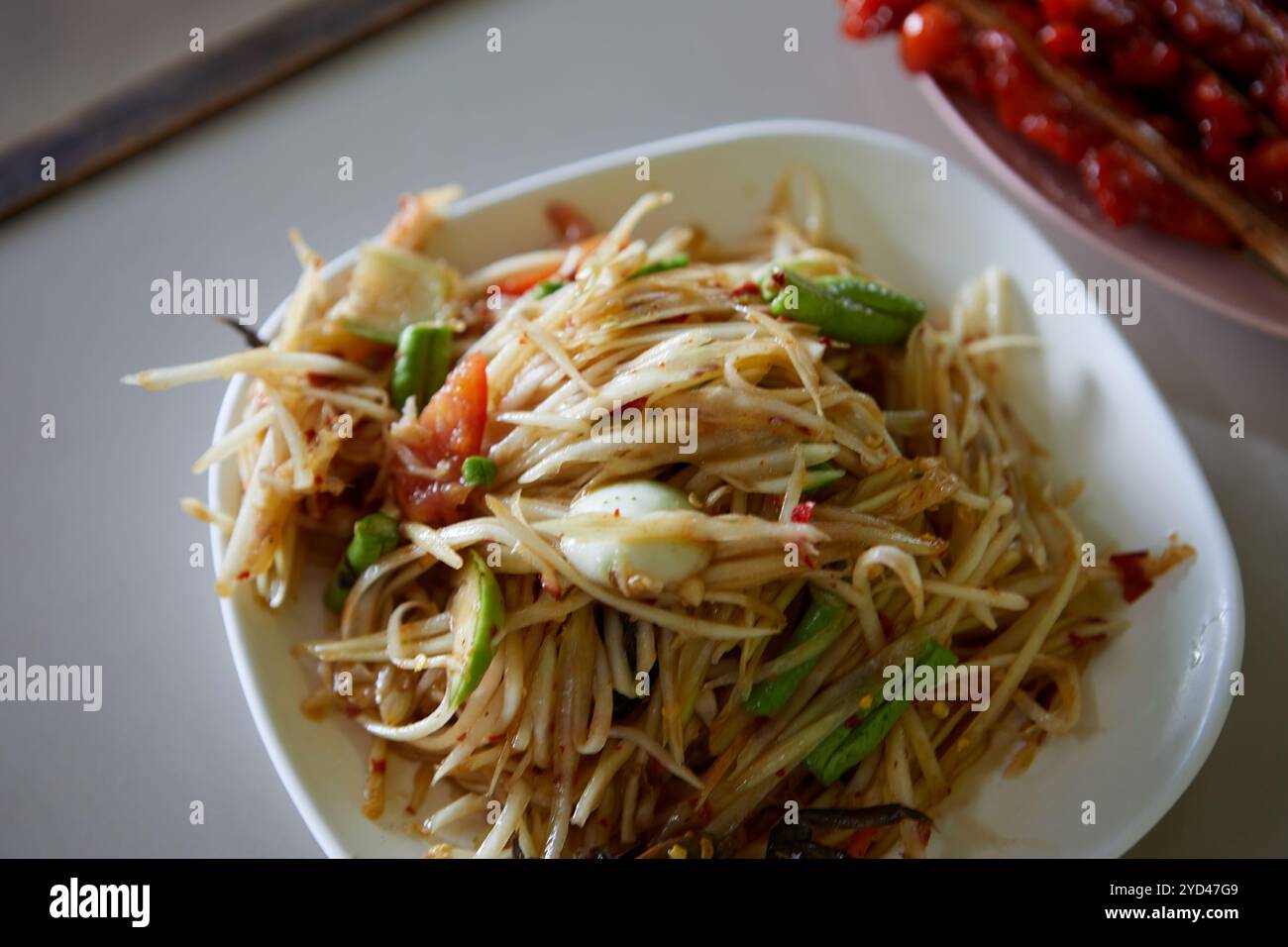 Spicy green papaya saladÂ or Som Tum Thai food served on plate Stock ...