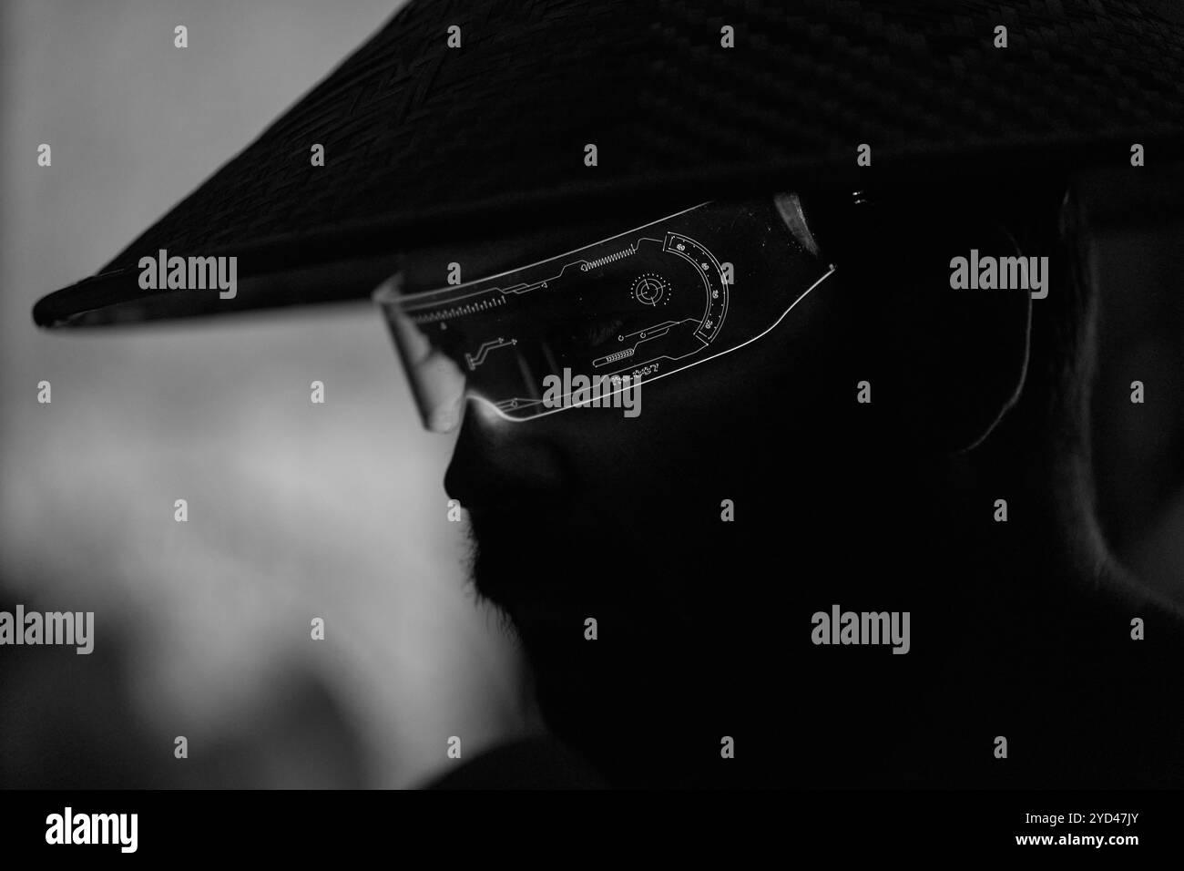 Man wearing a high-tech visor and hat in shadow Stock Photo - Alamy