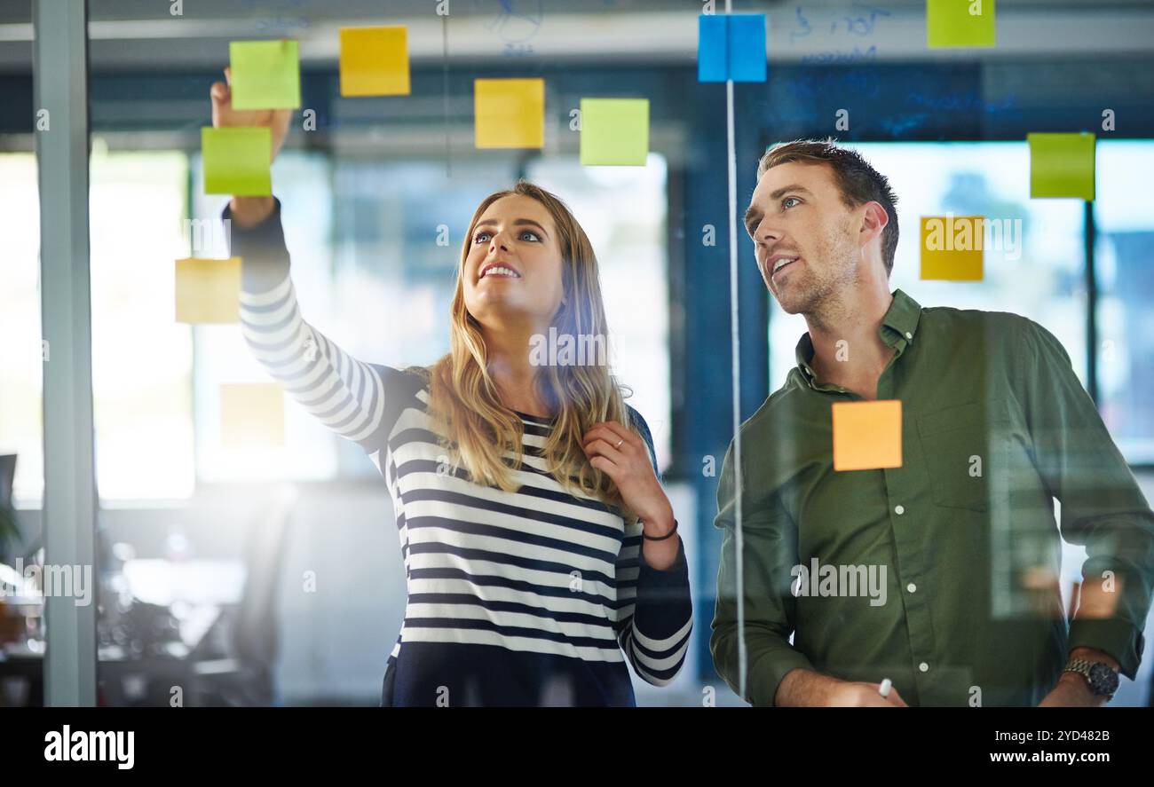 Business, people and session with notes on glass wall of planning ...