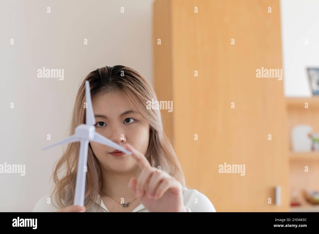 Young chinese woman playing with windmill Stock Photo - Alamy