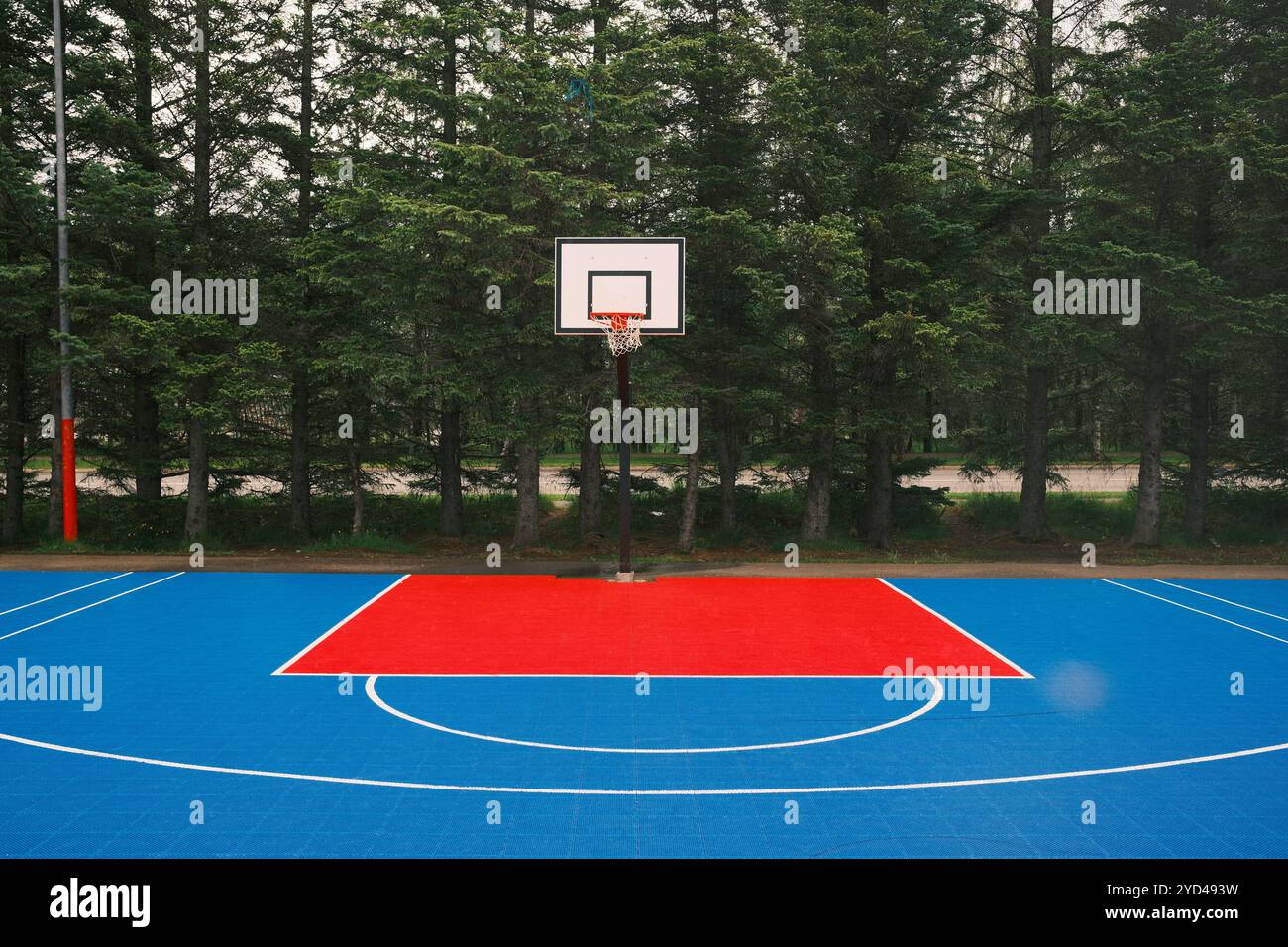 Basketball court with red and blue flooring Stock Photo - Alamy