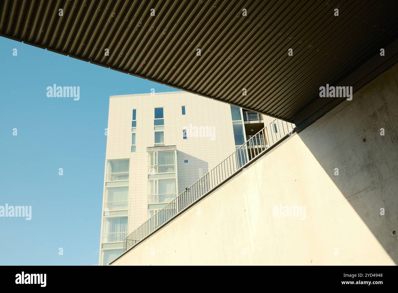 Facade of modern building with glass windows and underpass bridge Stock ...