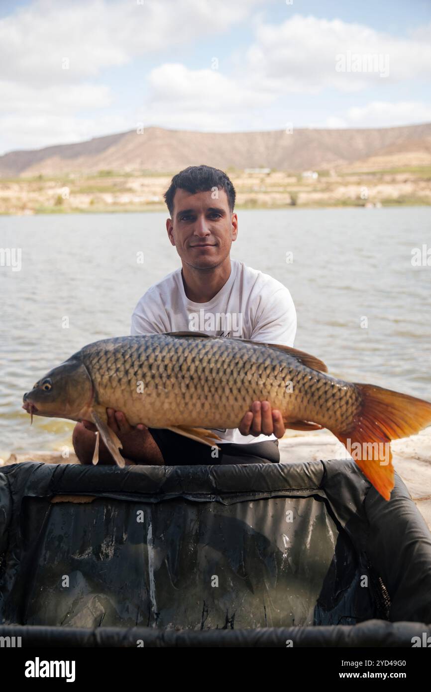 Young boy showing off a carp he just caught Stock Photo - Alamy