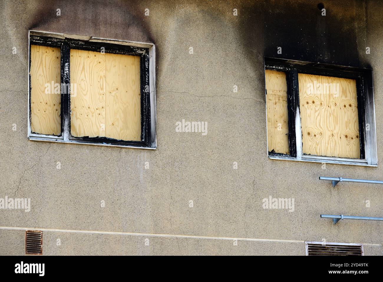 Windows boarded up with plywood after a fire Stock Photo - Alamy