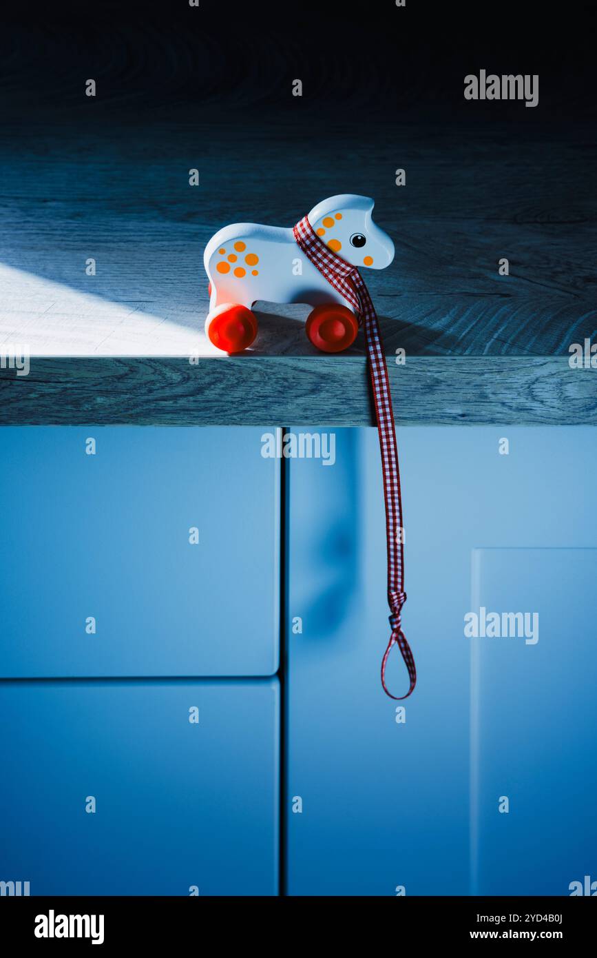 Child's toy on the edge of a worktop Stock Photo - Alamy
