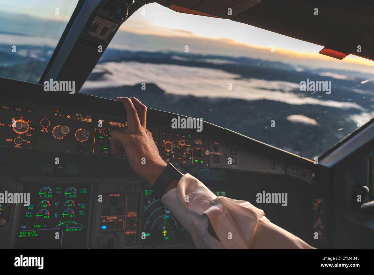 Fingers of a male pilot rotating cockpit dial Stock Photo - Alamy
