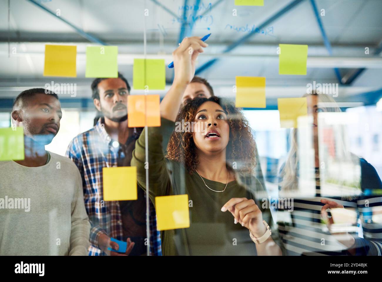 Group, people and writing for notes on glass wall with planning, future ...