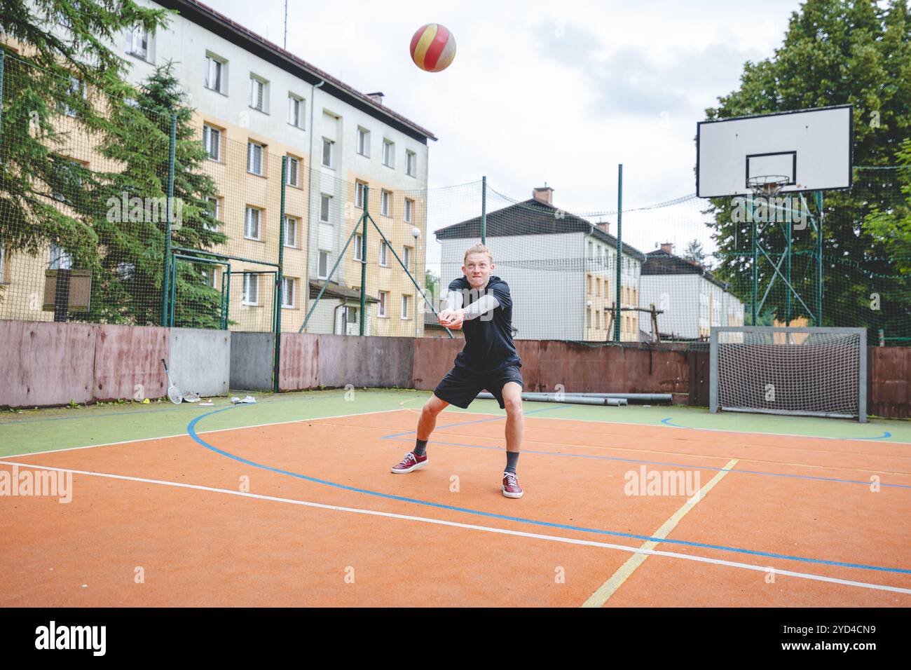 Volleyball player is passing on a hard court during an outdoor practice ...