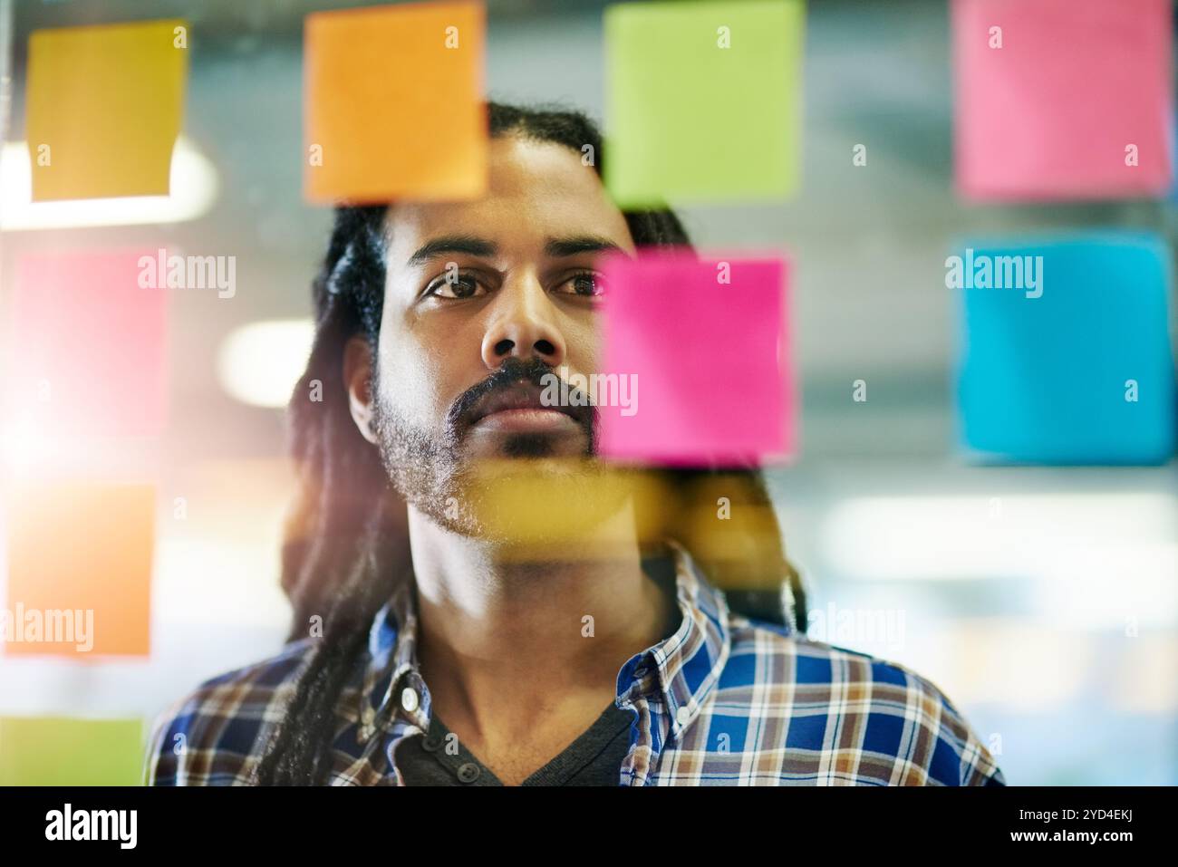 Thinking, business and man with notes on glass wall for planning ...