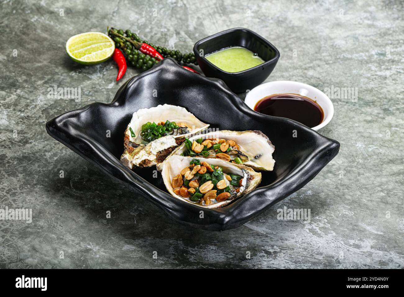 Open half oysters with green onion and peanut Stock Photo - Alamy
