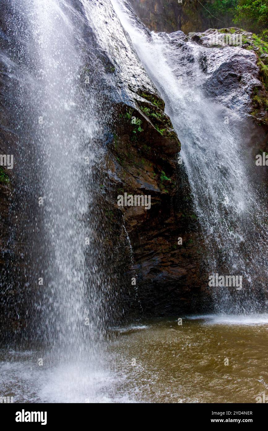 Water from the waterfall splashing through the rocks into a water well ...