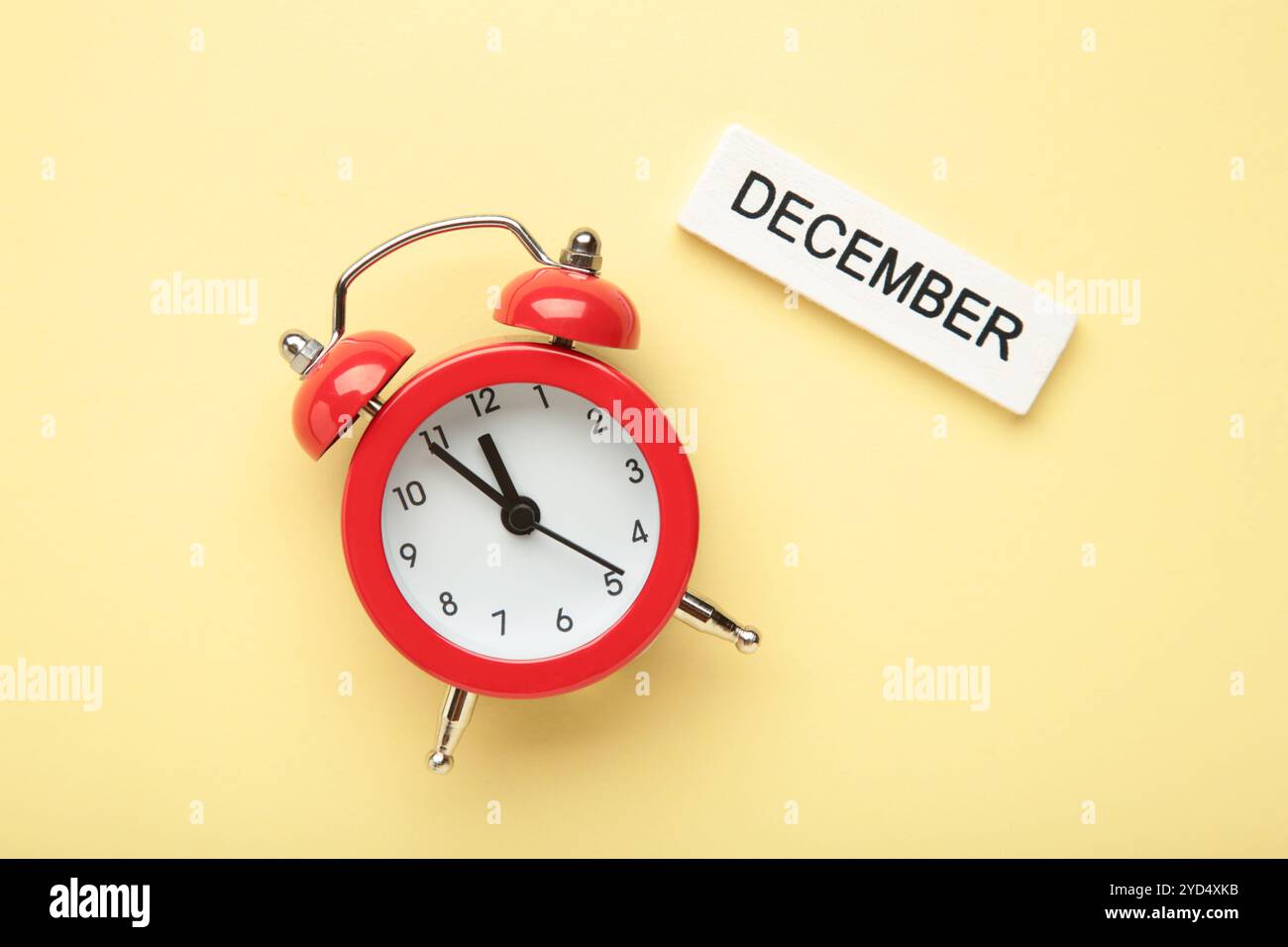 December 2024 Monthly calendar year with alarm clock on beige ...