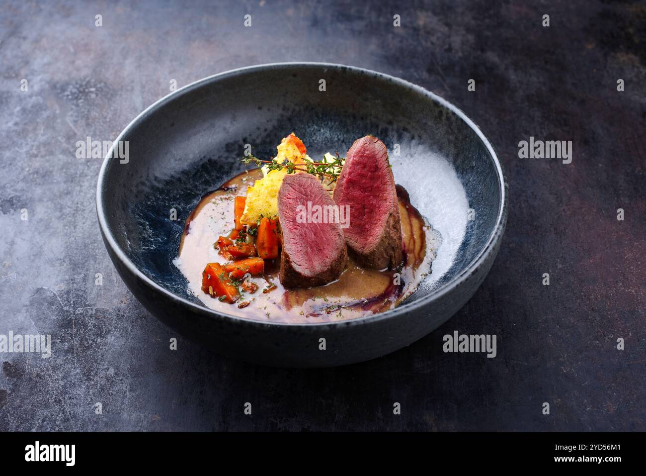 Traditional fried venison back filet with kaki fruit Stock Photo - Alamy
