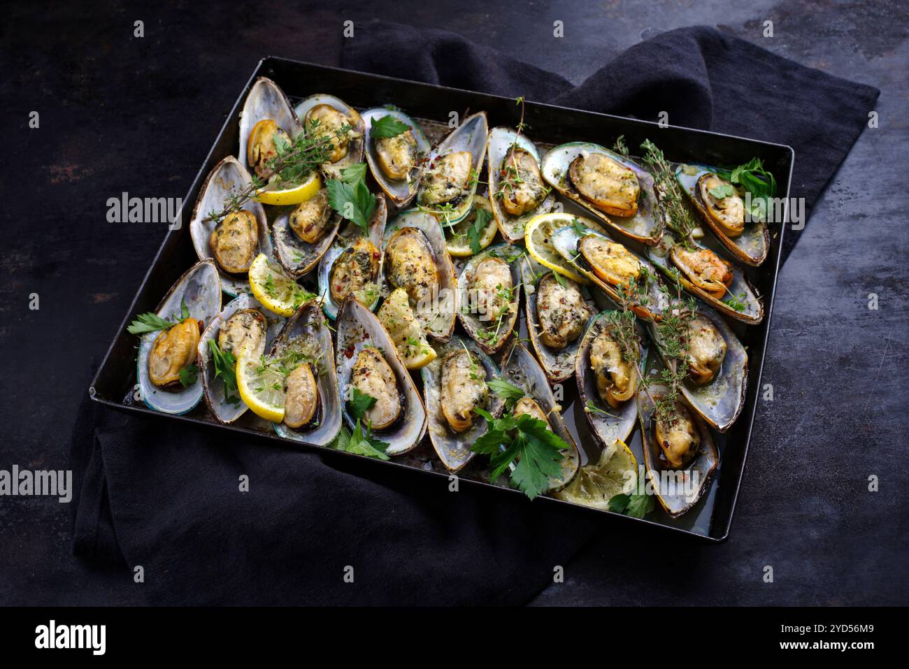 Traditional New Zealand green scallops halved and gratinated with herbs ...