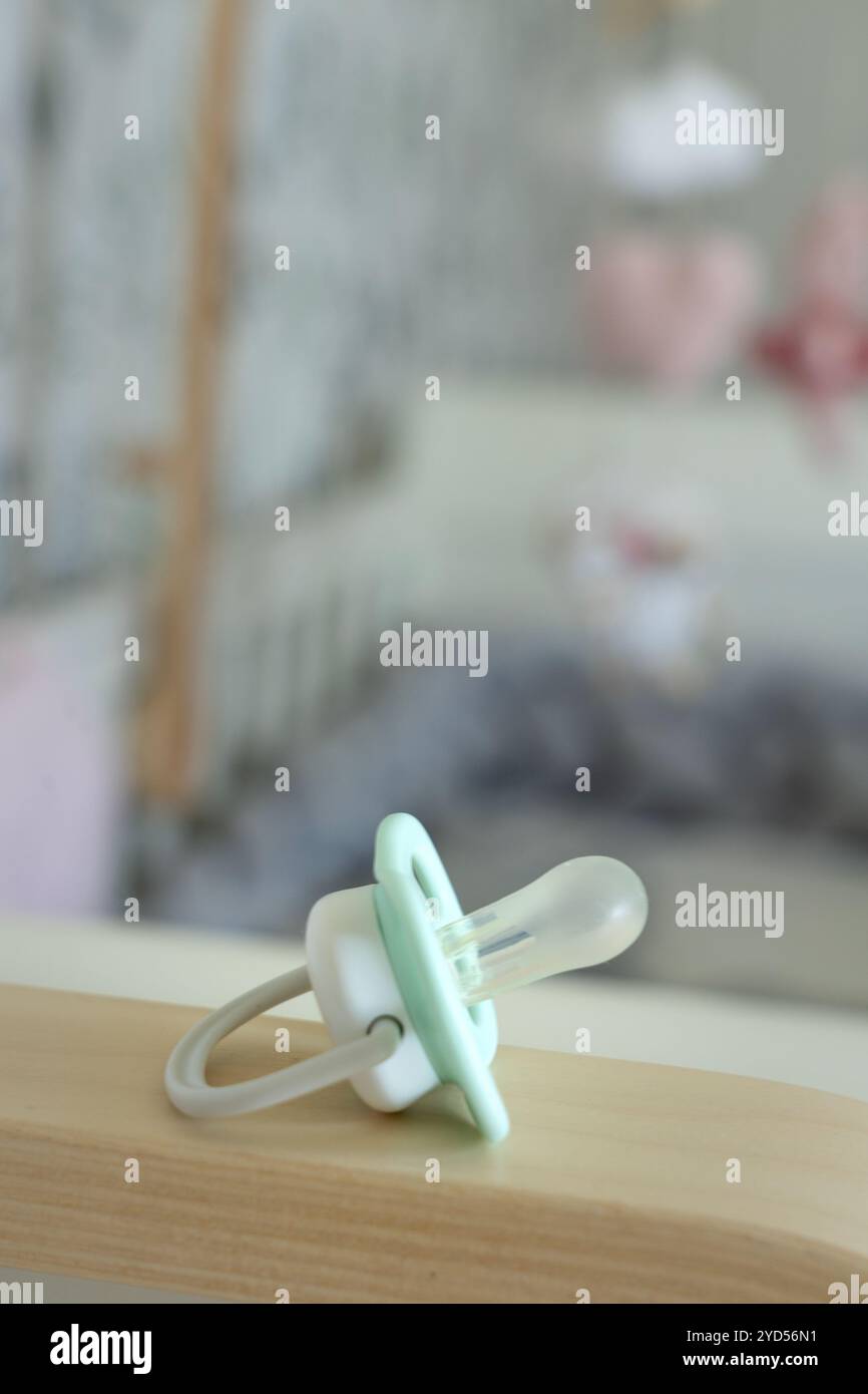 pacifier with a baby room nursery background light pastel colors Stock ...