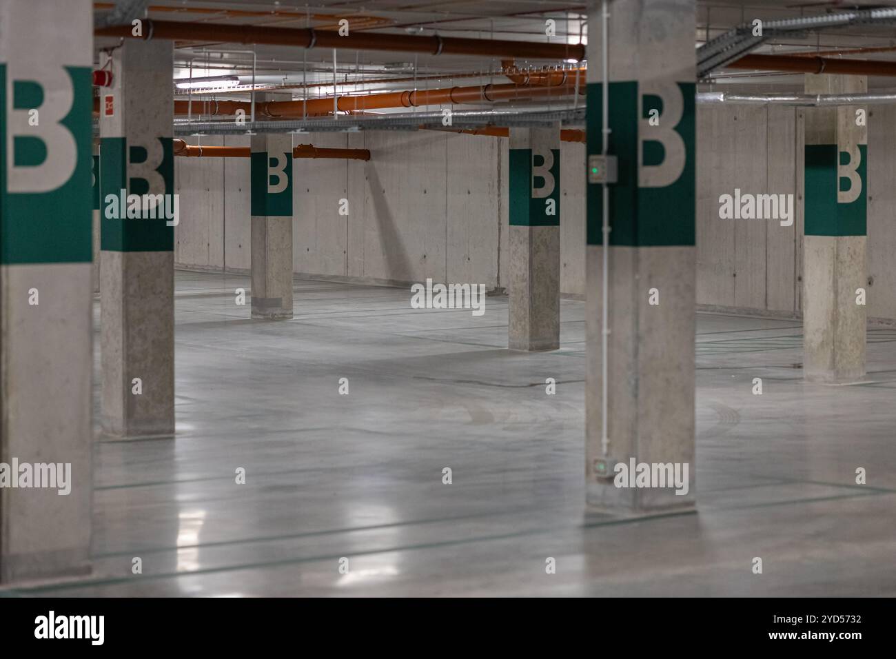 Modern, spacious and empty parking facility, featuring industrial ...