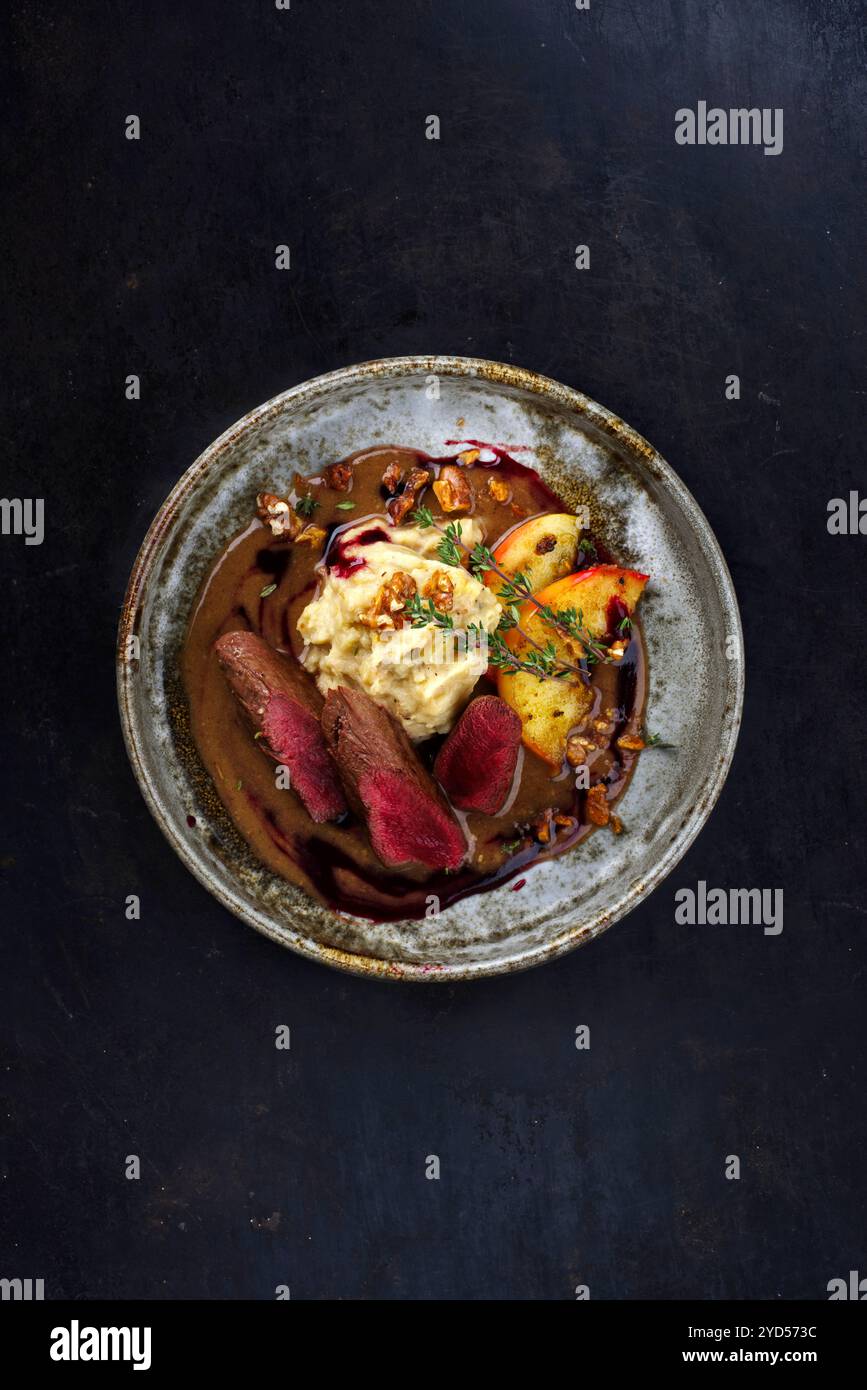 Traditional fried venison back filet with kaki fruit Stock Photo - Alamy