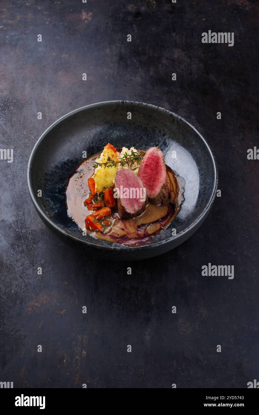 Traditional fried venison back filet with kaki fruit Stock Photo - Alamy