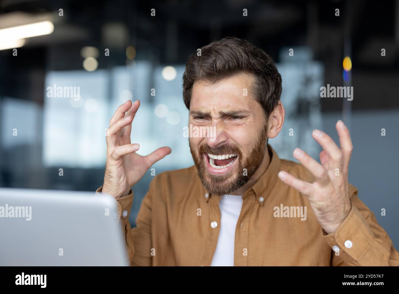 Mature businessman in office demonstrates frustration and stress with ...